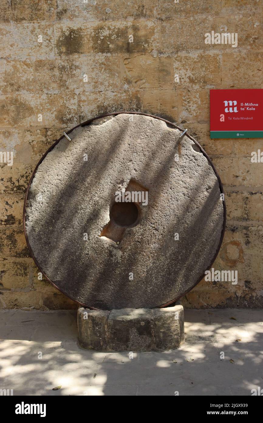 A millstone standing at the entrance of the Ta’ Kola windmill tourist ...