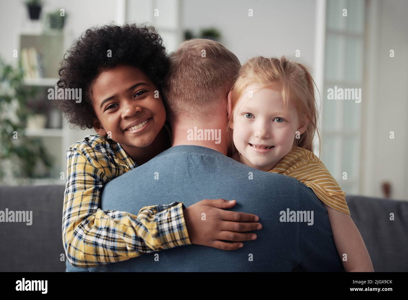 Portrait of happy multiethnic children smiling at camera while ...