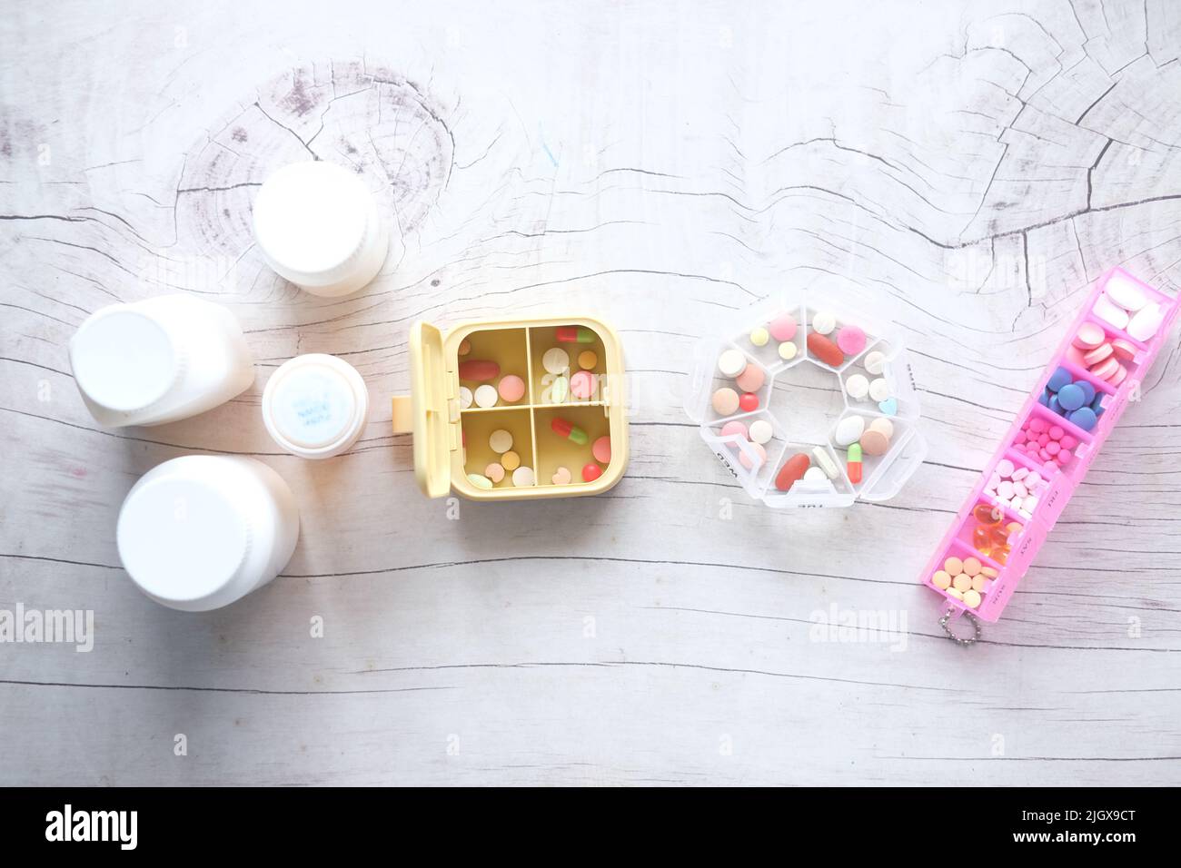 top view of medical pill box and container on table Stock Photo - Alamy