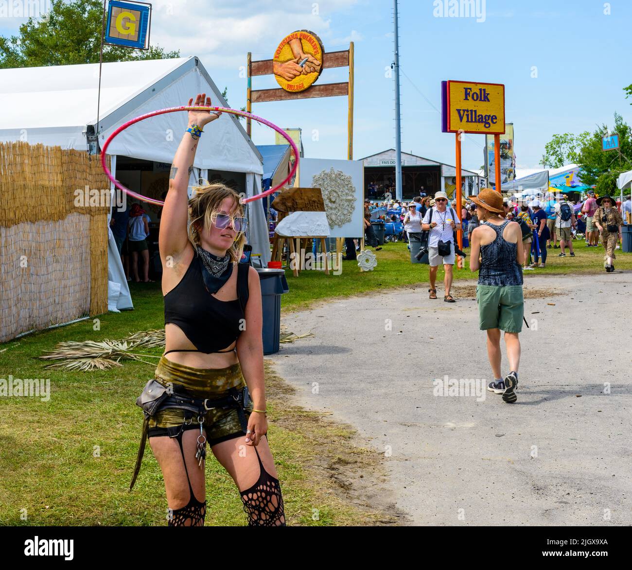 NEW ORLEANS, LA, USA - April 29, 2022: Woman dances with a hula hoop at ...