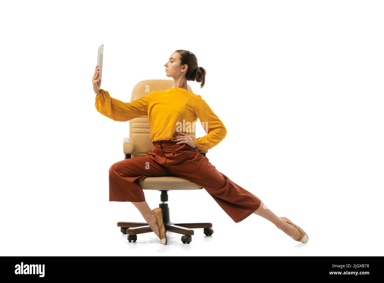Portrait of young pretty girl, office worker in stylish attire dancing ...