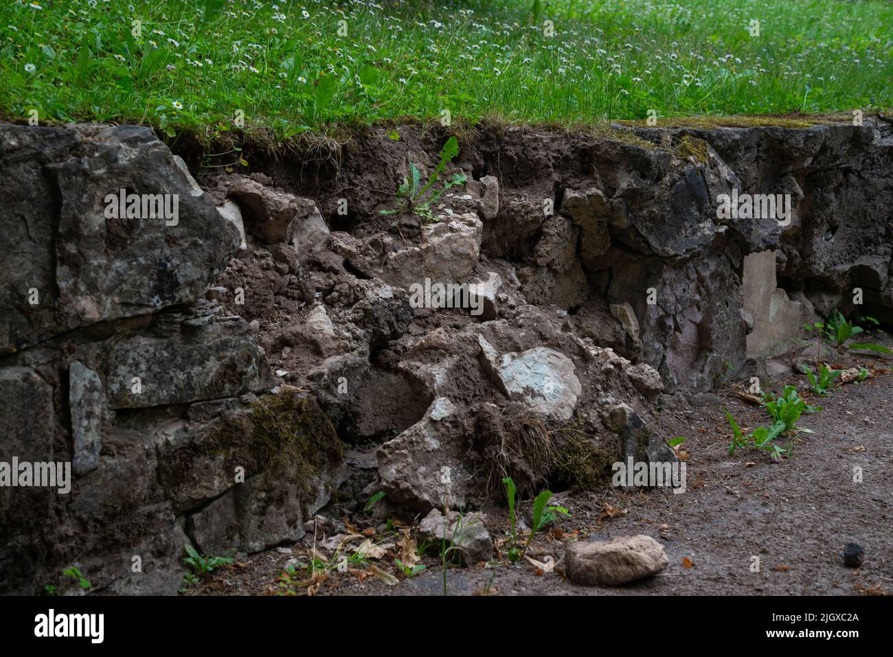 collapsed stone wall. A wall of stones built to hold the shore next to ...