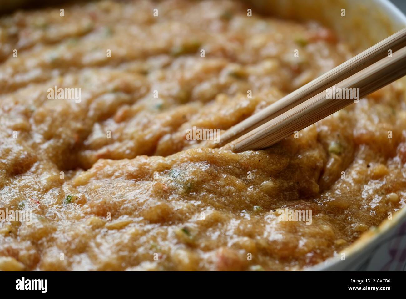 extreme close up of stuffing and chopsticks in bowl. Prepare ...