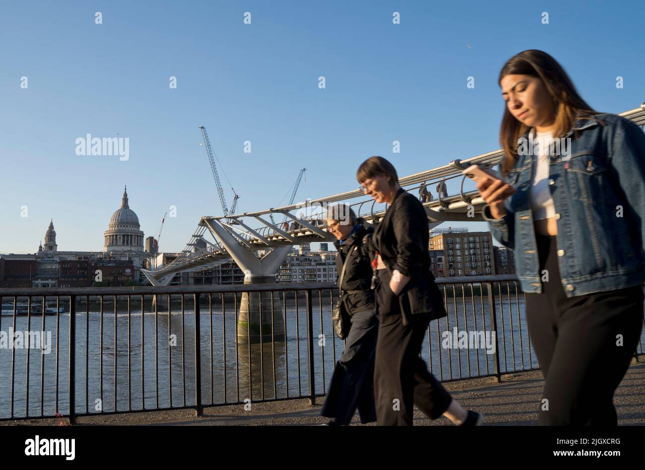 Visitors to the South Bank riverside walks with St. Paul's cathedral in ...