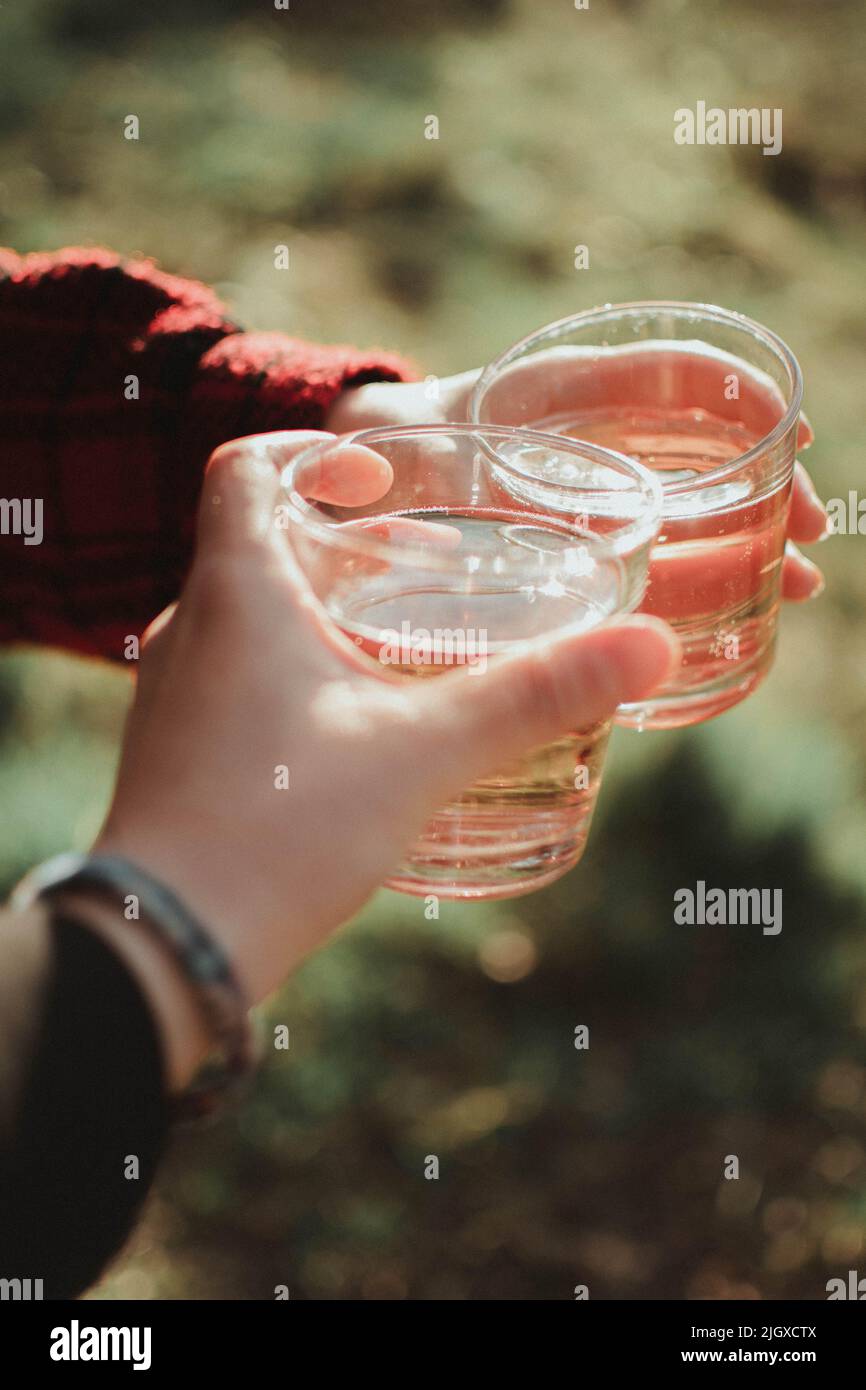 Two hands making cheers with glasses of soda Stock Photo - Alamy