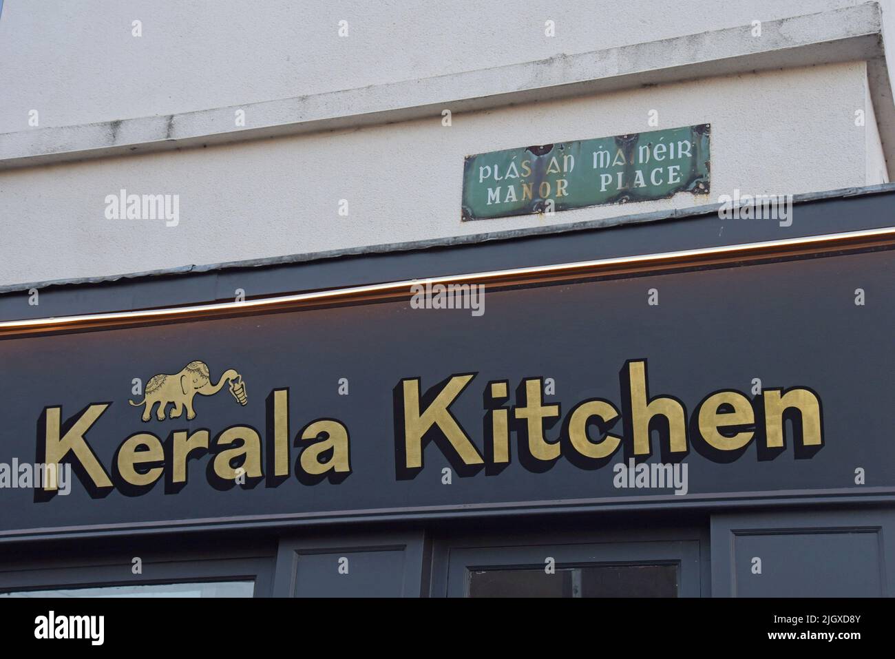 A Bilingual vintage street sign and restaurant sign in the trendy inner ...
