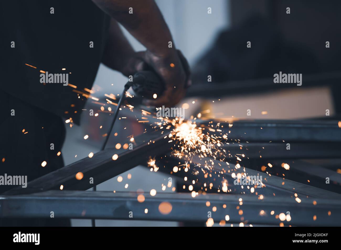 Profesional fabric worker cutting metal profile on the work table with ...