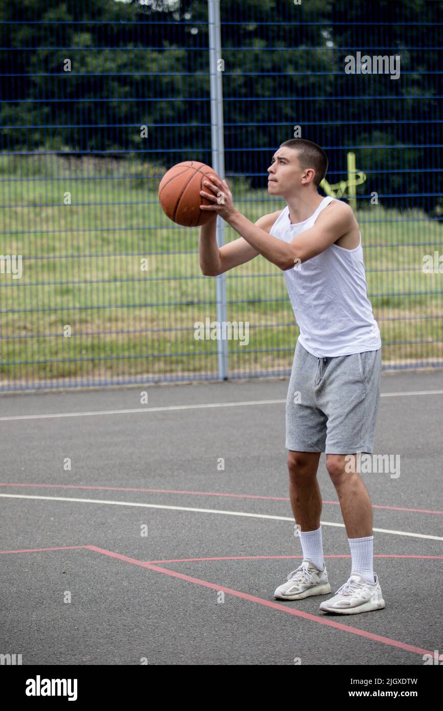 A Nineteen Year Old Teenage Boy Shooting A Hoop in A Basketball Court ...