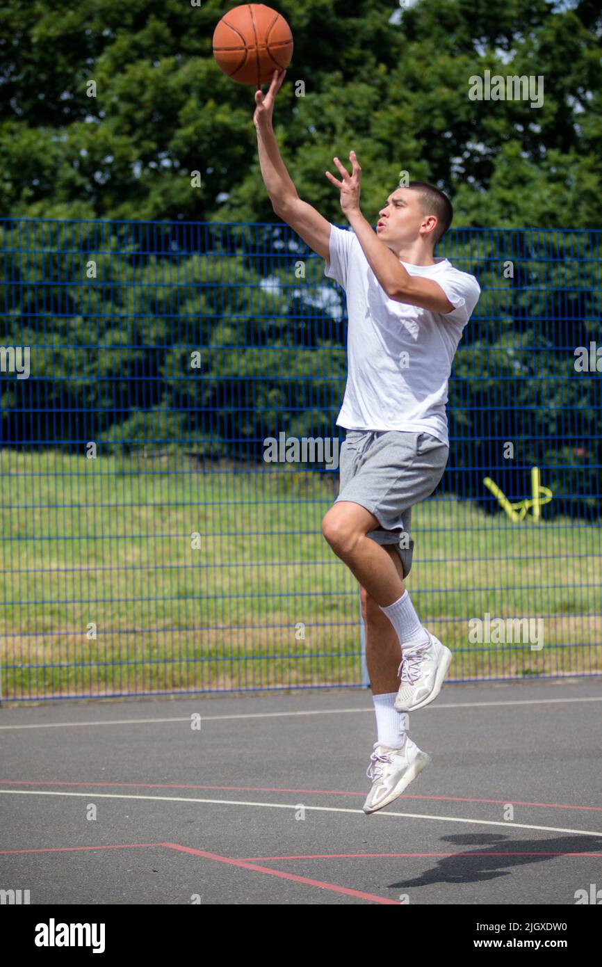 A Nineteen Year Old Teenage Boy Shooting A Hoop in A Basketball Court ...