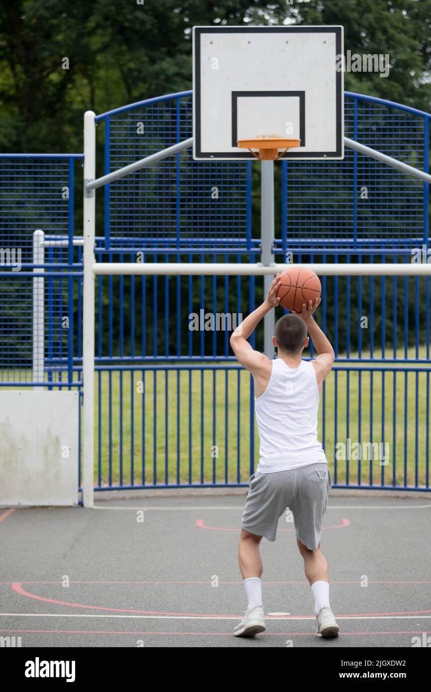 A Nineteen Year Old Teenage Boy Shooting A Hoop in A Basketball Court ...