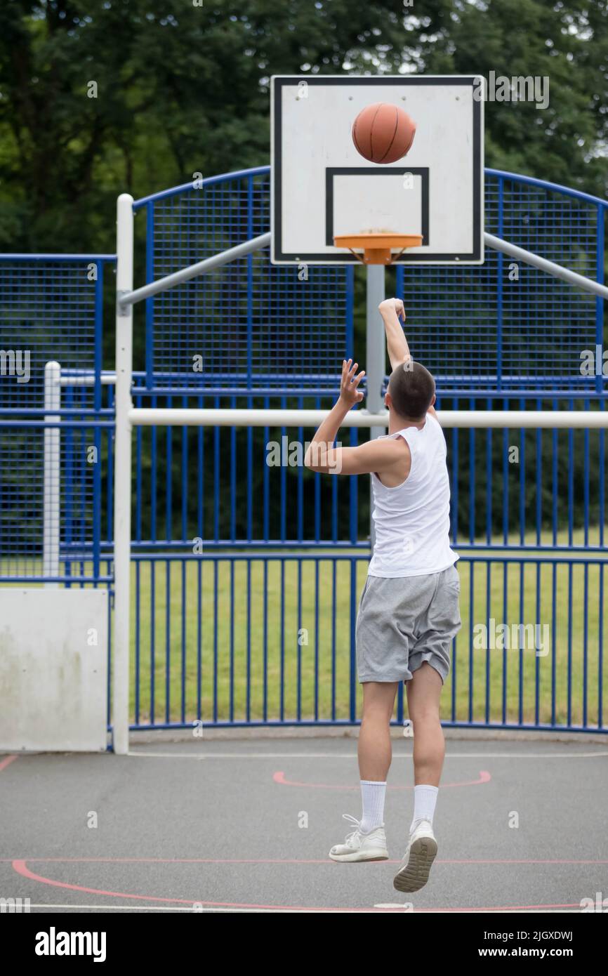 A Nineteen Year Old Teenage Boy Shooting A Hoop in A Basketball Court ...