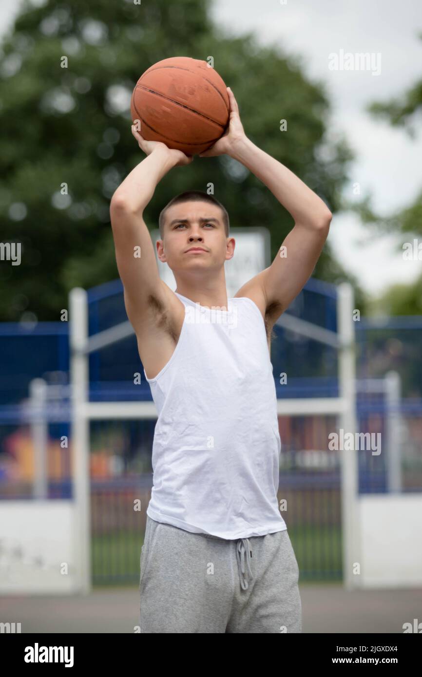 A Nineteen Year Old Teenage Boy Shooting A Hoop in A Basketball Court ...