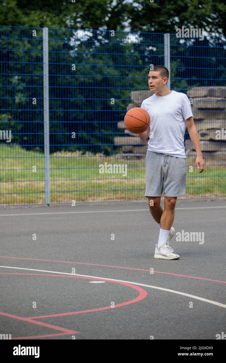 A Nineteen Year Old Teenage Boy Shooting A Hoop in A Basketball Court ...