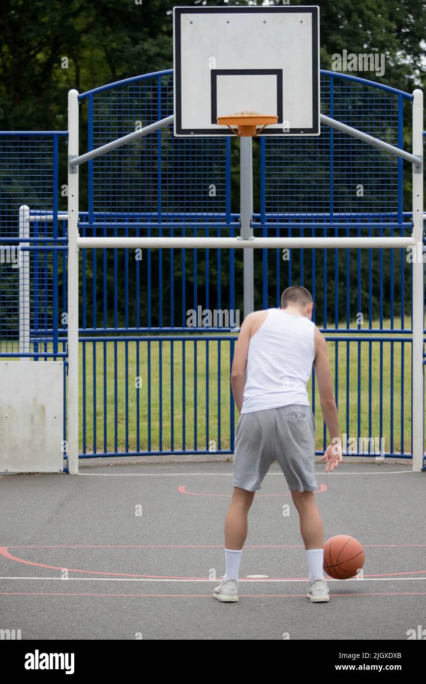 A Nineteen Year Old Teenage Boy Shooting A Hoop in A Basketball Court ...