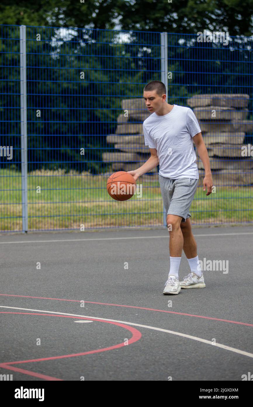 A Nineteen Year Old Teenage Boy Shooting A Hoop in A Basketball Court ...