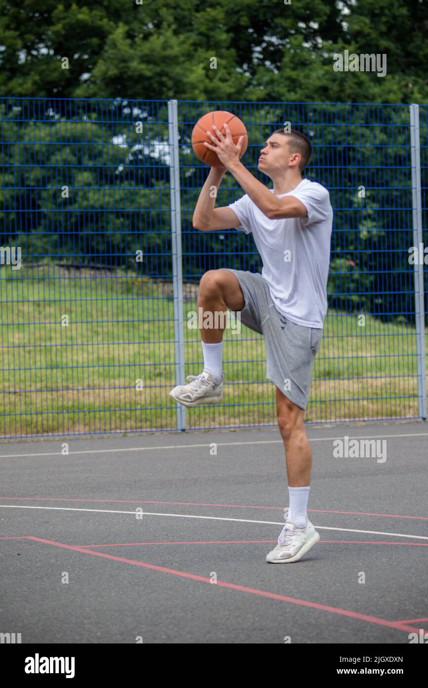 A Nineteen Year Old Teenage Boy Shooting A Hoop in A Basketball Court ...