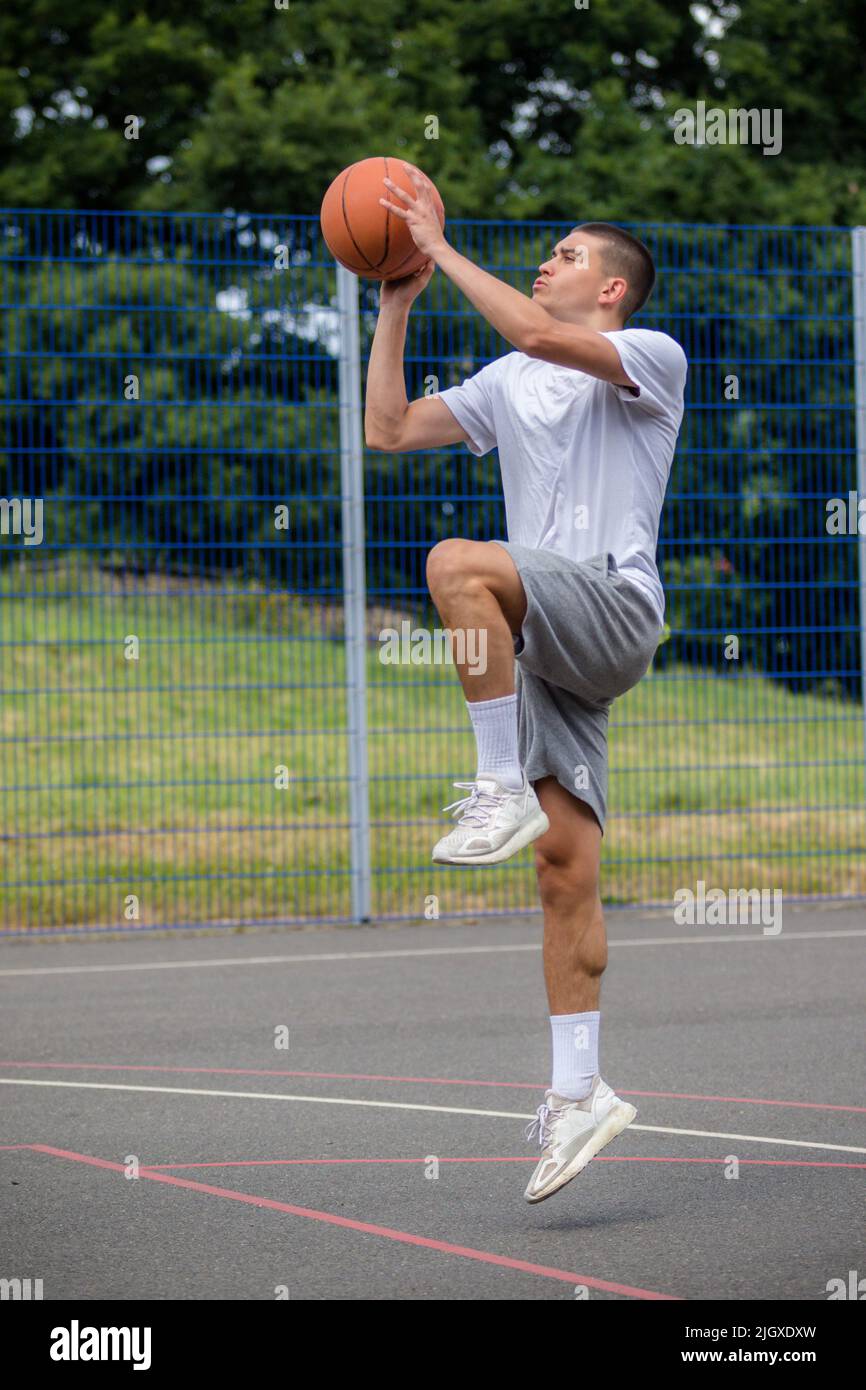 A Nineteen Year Old Teenage Boy Shooting A Hoop in A Basketball Court ...