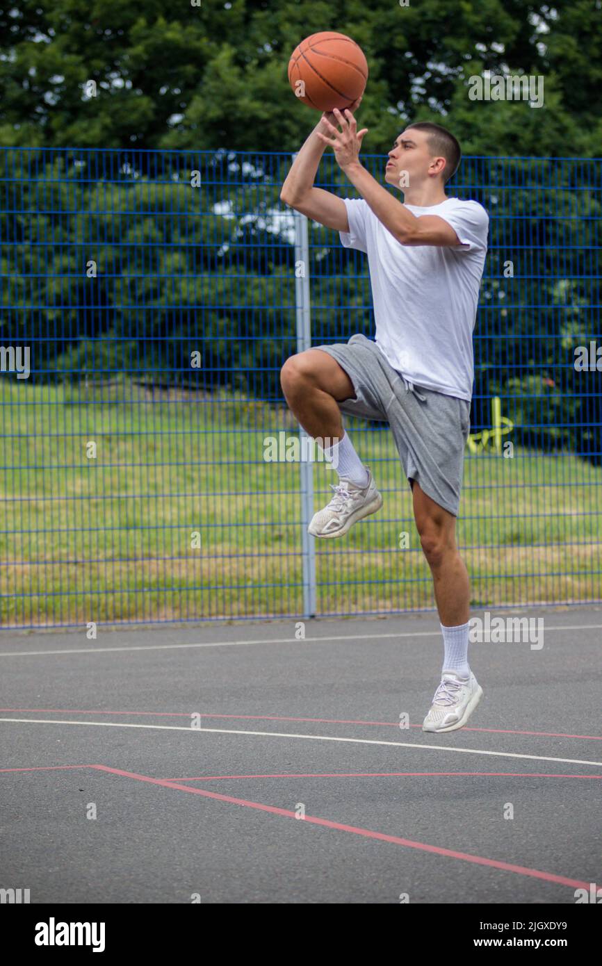 A Nineteen Year Old Teenage Boy Shooting A Hoop in A Basketball Court ...