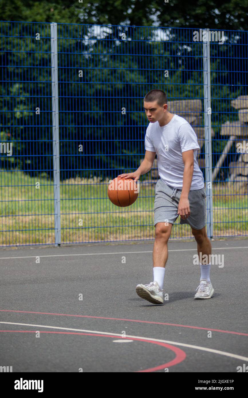 A Nineteen Year Old Teenage Boy Shooting A Hoop in A Basketball Court ...