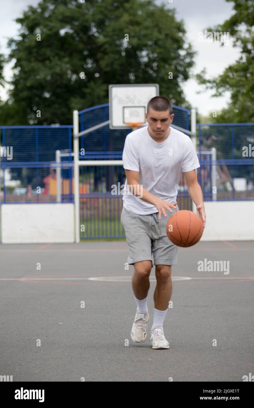 A Nineteen Year Old Teenage Boy Shooting A Hoop in A Basketball Court ...