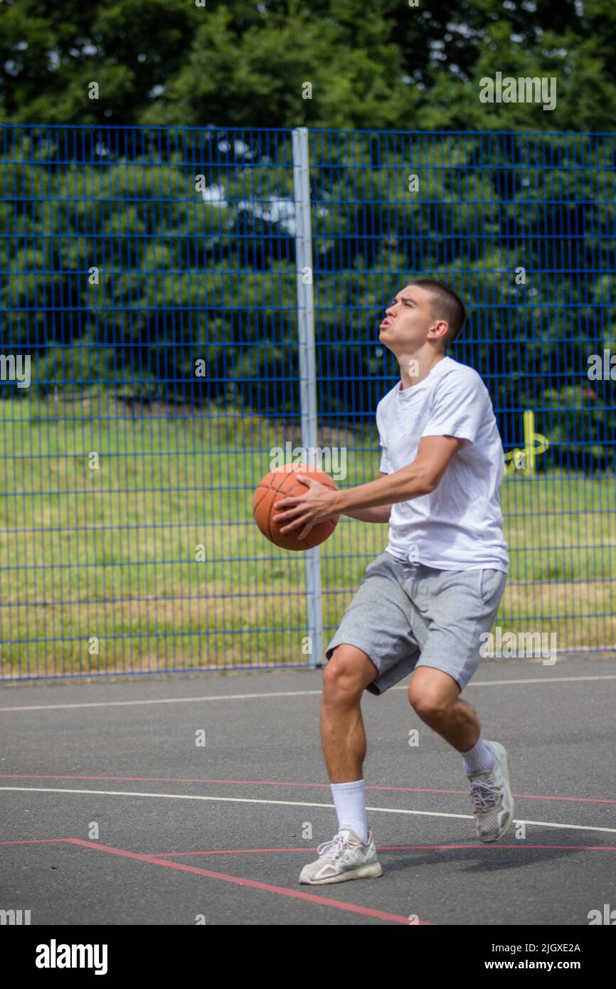 A Nineteen Year Old Teenage Boy Shooting A Hoop in A Basketball Court ...