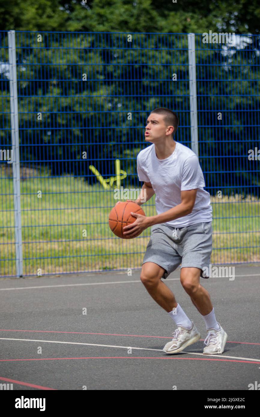 A Nineteen Year Old Teenage Boy Shooting A Hoop in A Basketball Court ...