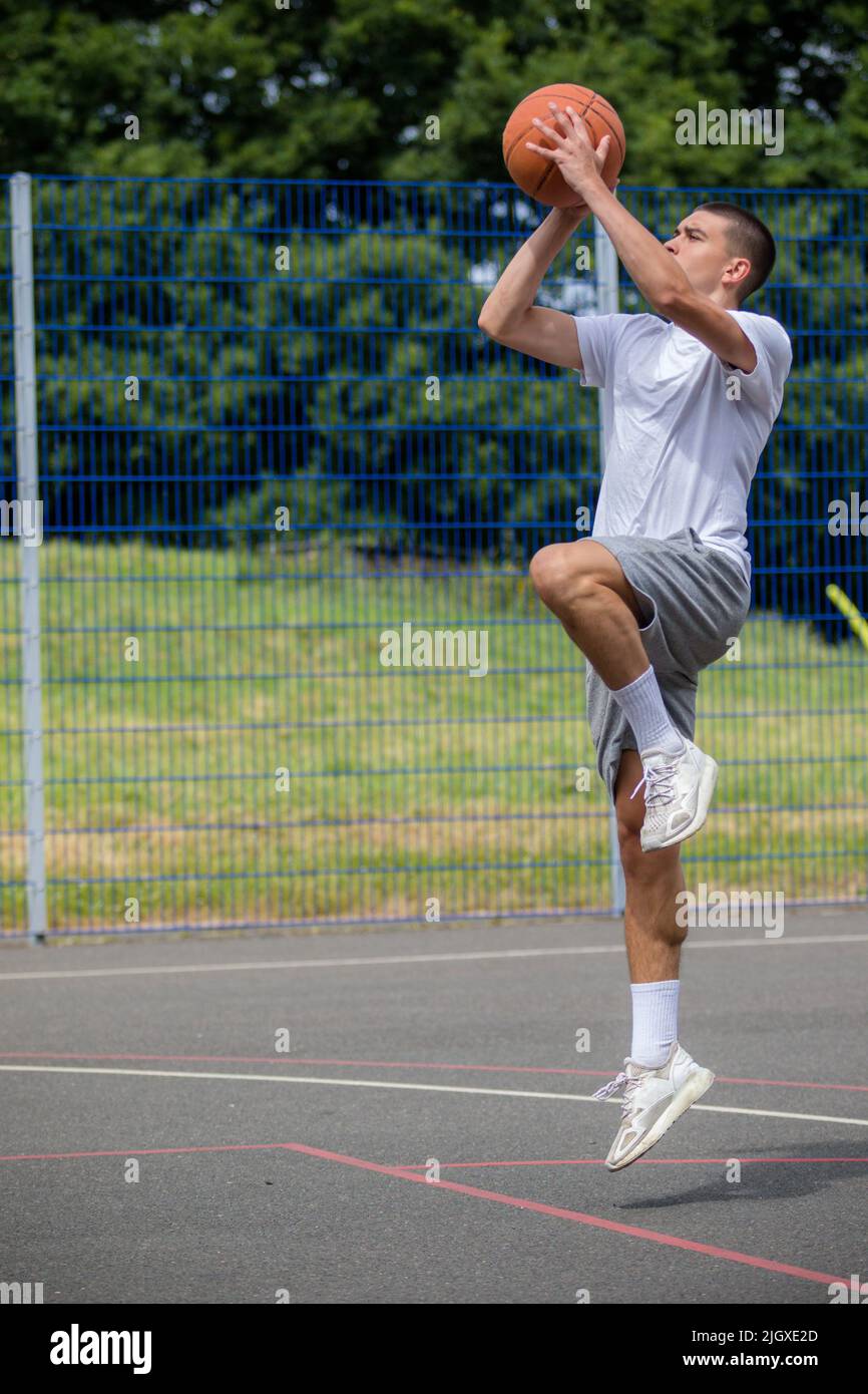 A Nineteen Year Old Teenage Boy Shooting A Hoop in A Basketball Court ...