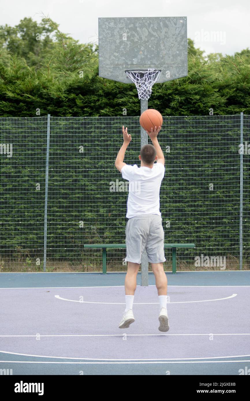 A Nineteen Year Old Teenage Boy Shooting A Hoop in A Basketball Court ...