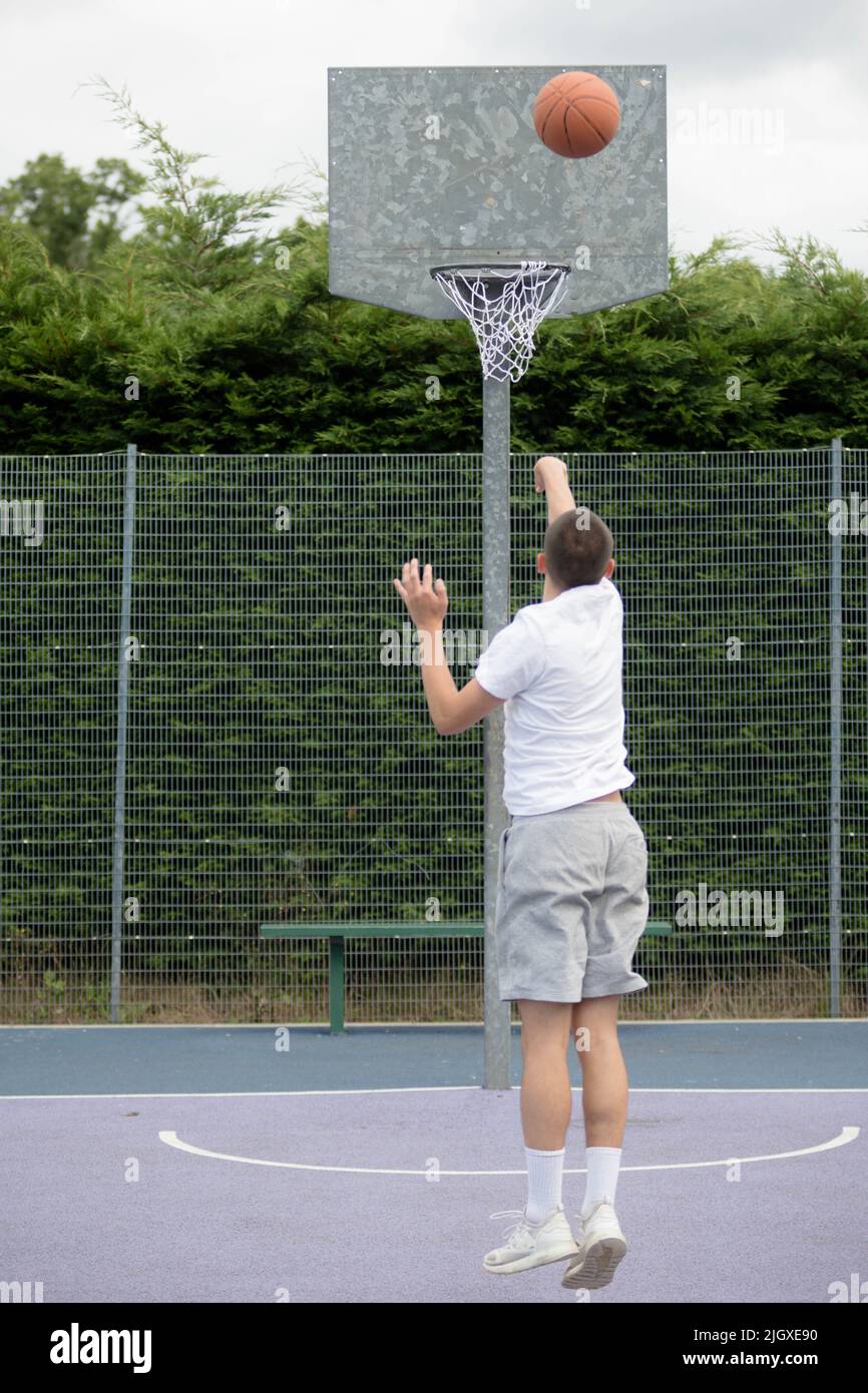 A Nineteen Year Old Teenage Boy Shooting A Hoop in A Basketball Court ...