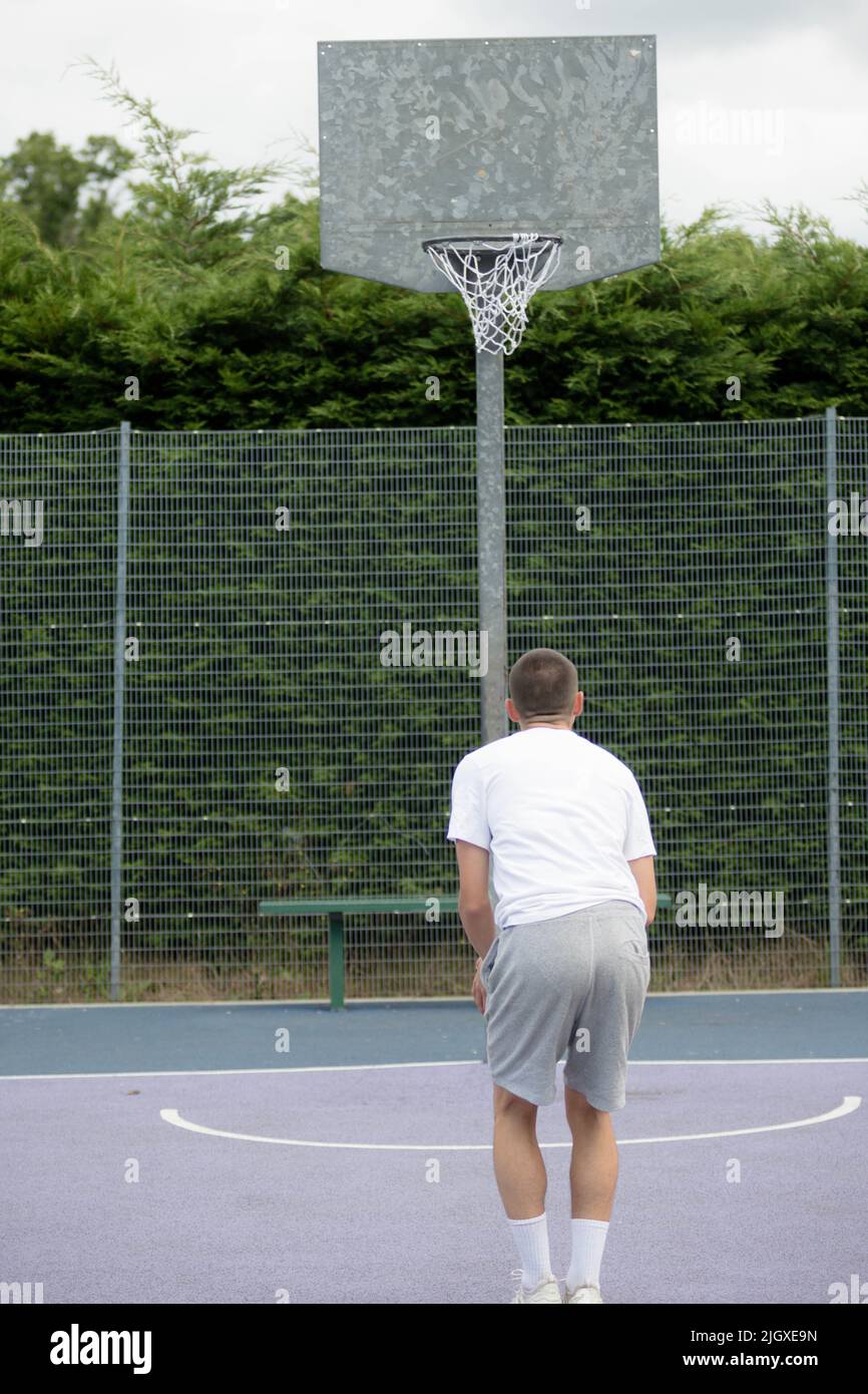 A Nineteen Year Old Teenage Boy Shooting A Hoop in A Basketball Court ...