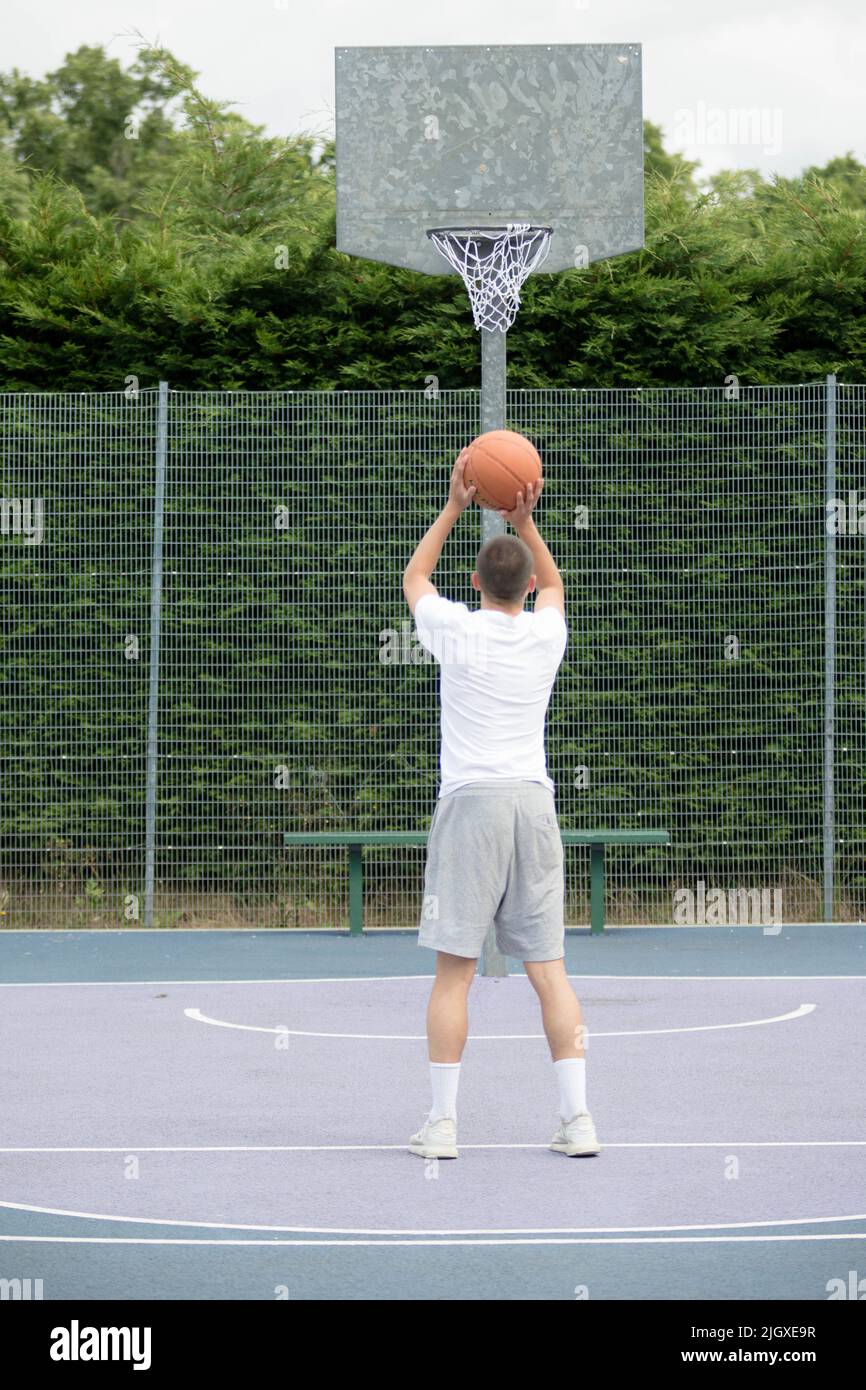 A Nineteen Year Old Teenage Boy Shooting A Hoop in A Basketball Court ...