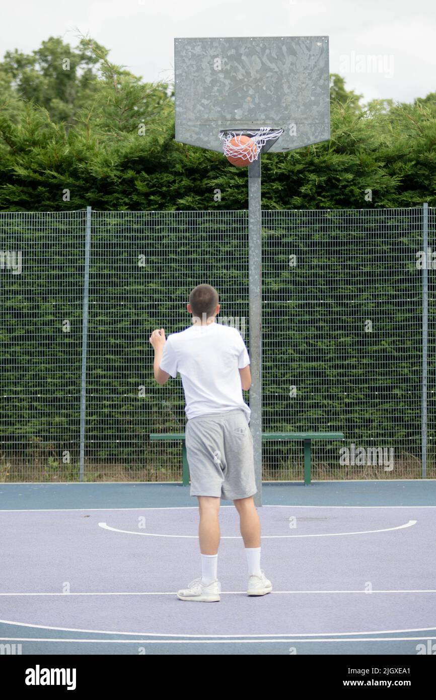 A Nineteen Year Old Teenage Boy Shooting A Hoop in A Basketball Court ...