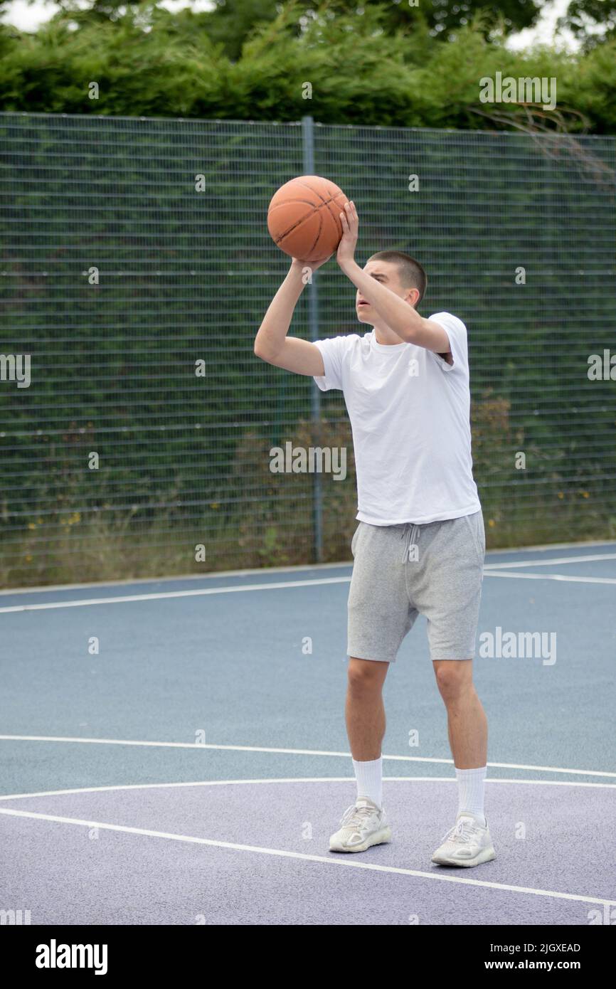 A Nineteen Year Old Teenage Boy Shooting A Hoop in A Basketball Court ...