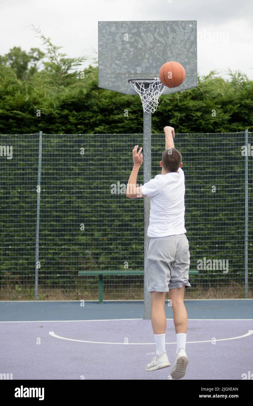 A Nineteen Year Old Teenage Boy Shooting A Hoop in A Basketball Court ...