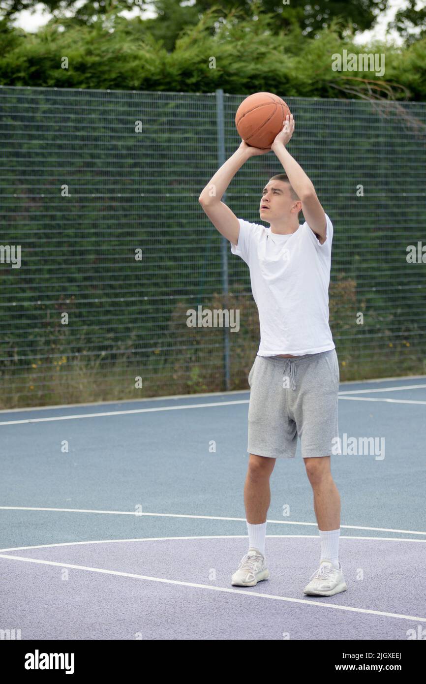 A Nineteen Year Old Teenage Boy Shooting A Hoop in A Basketball Court ...
