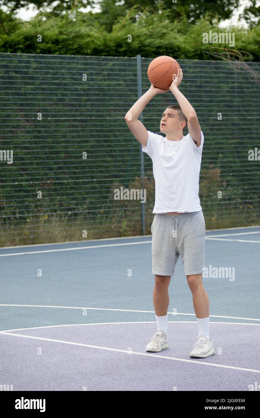 A Nineteen Year Old Teenage Boy Shooting A Hoop in A Basketball Court ...