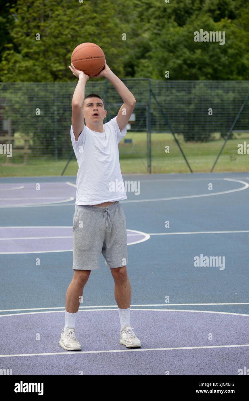 A Nineteen Year Old Teenage Boy Shooting A Hoop in A Basketball Court ...