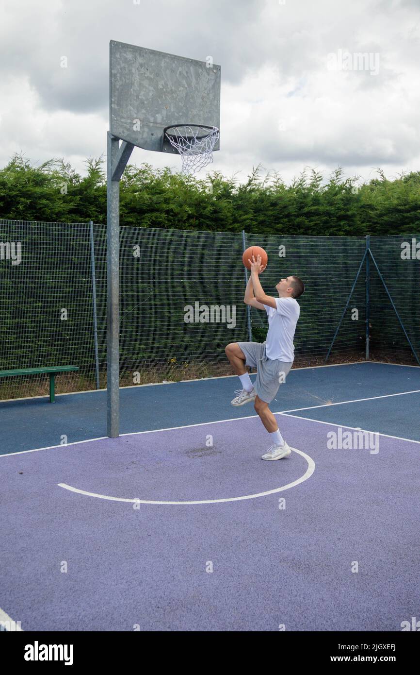 A Nineteen Year Old Teenage Boy Shooting A Hoop in A Basketball Court ...