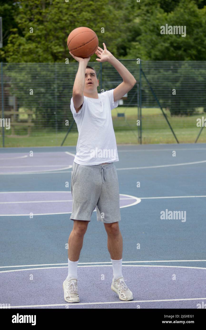 A Nineteen Year Old Teenage Boy Shooting A Hoop in A Basketball Court ...