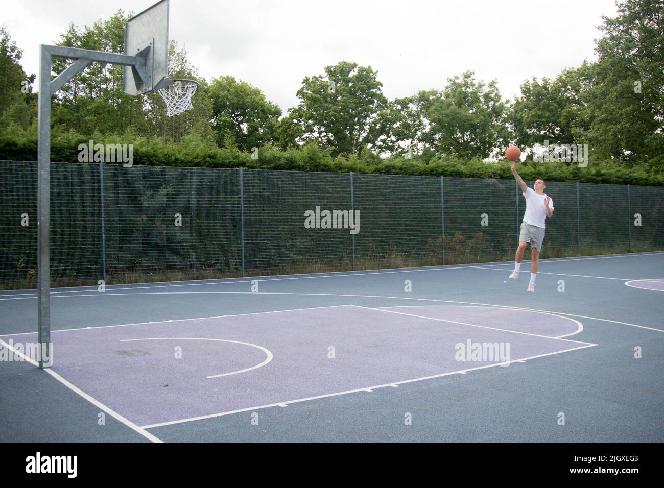 A Nineteen Year Old Teenage Boy Shooting A Hoop in A Basketball Court ...