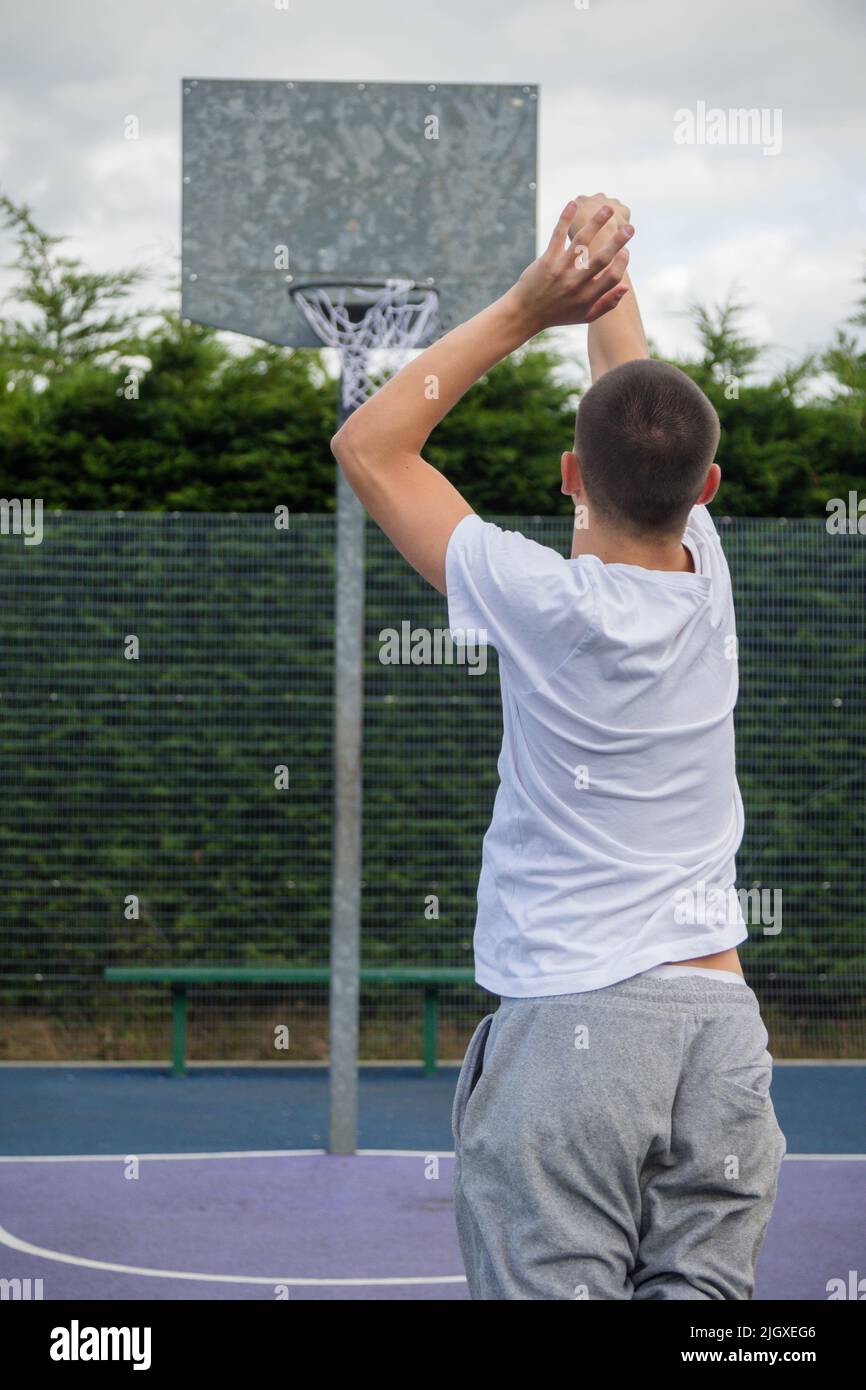 A Nineteen Year Old Teenage Boy Shooting A Hoop in A Basketball Court ...