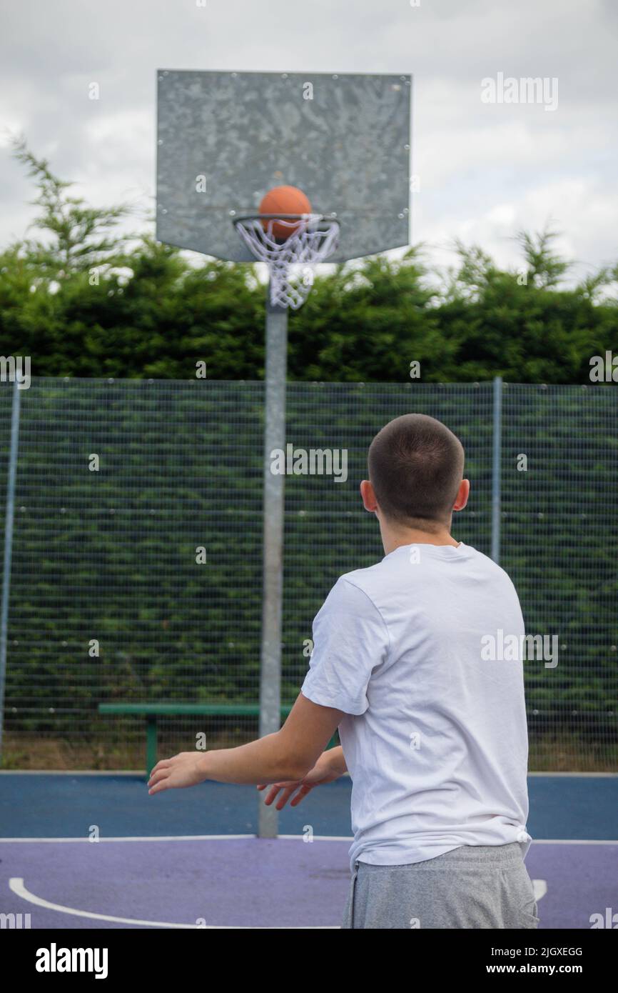 A Nineteen Year Old Teenage Boy Shooting A Hoop in A Basketball Court ...
