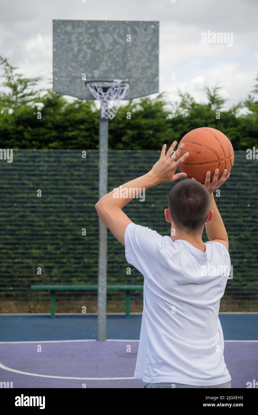 A Nineteen Year Old Teenage Boy Shooting A Hoop in A Basketball Court ...