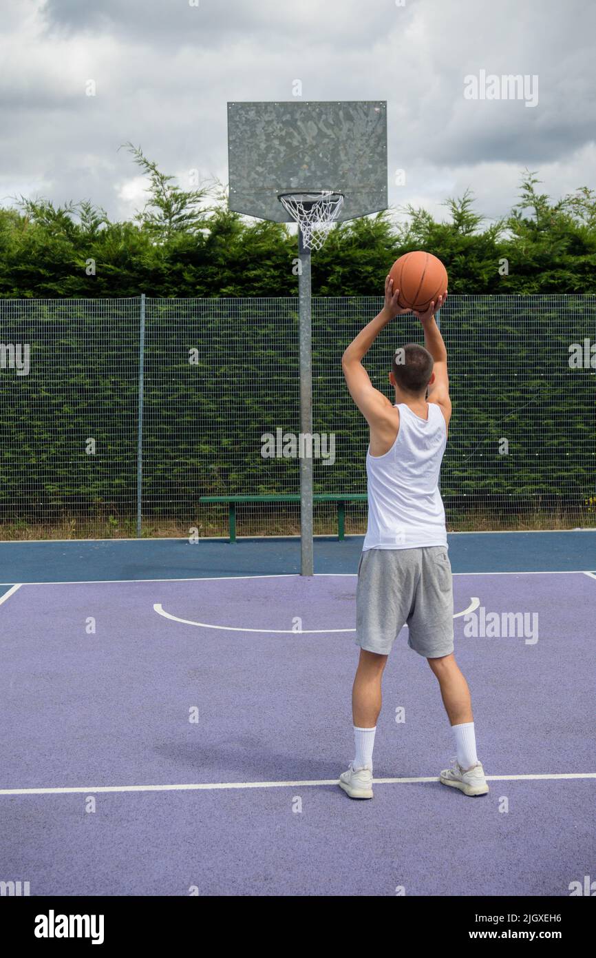 A Nineteen Year Old Teenage Boy Shooting A Hoop in A Basketball Court ...