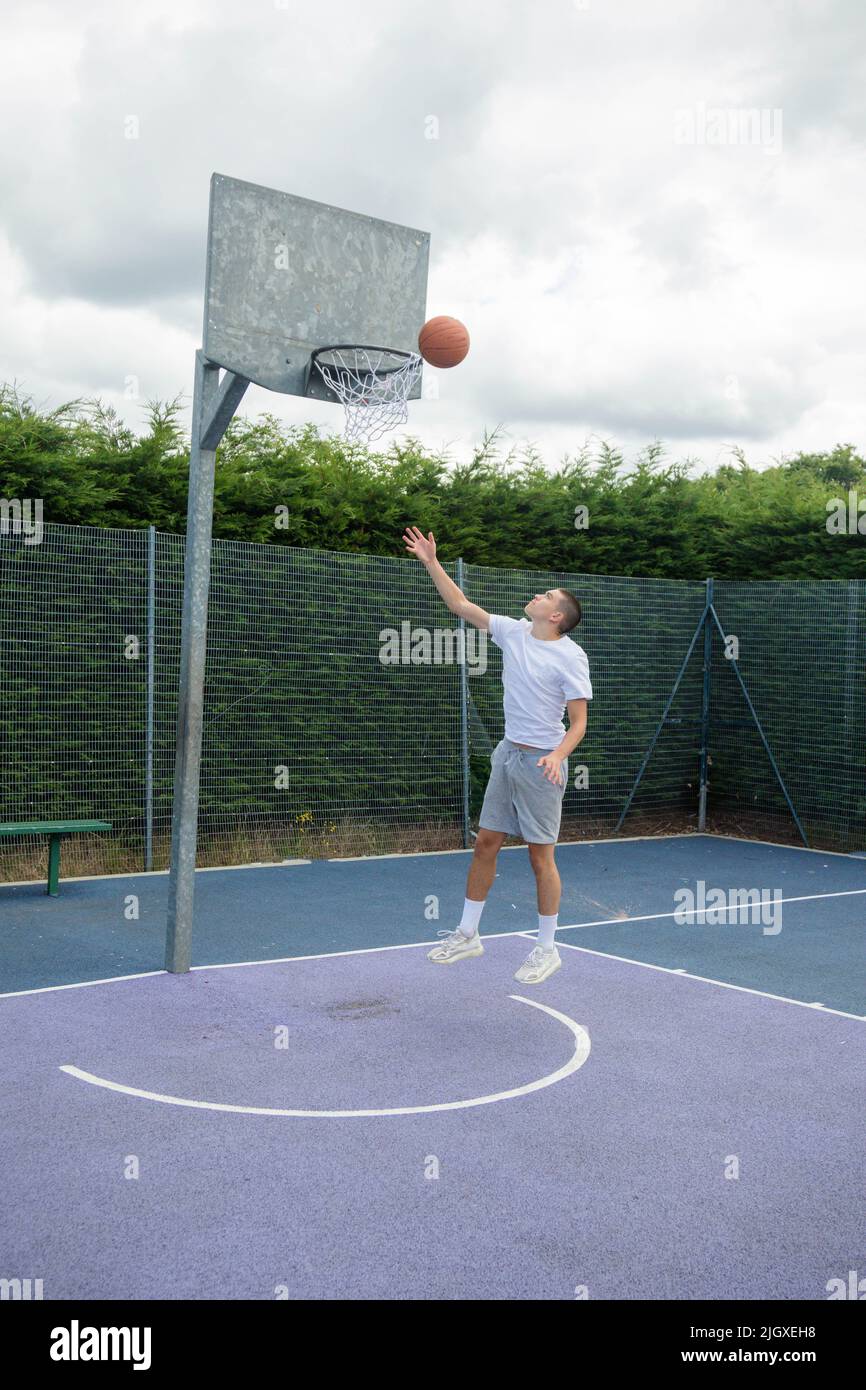 A Nineteen Year Old Teenage Boy Shooting A Hoop in A Basketball Court ...