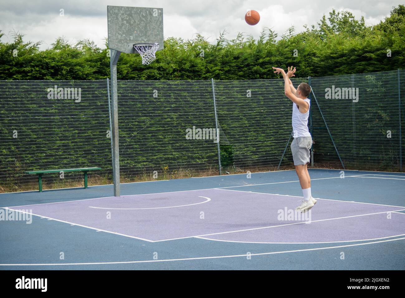 A Nineteen Year Old Teenage Boy Shooting A Hoop in A Basketball Court ...