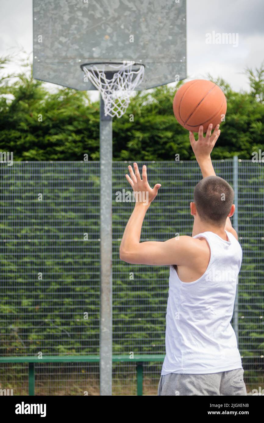 A Nineteen Year Old Teenage Boy Shooting A Hoop in A Basketball Court ...