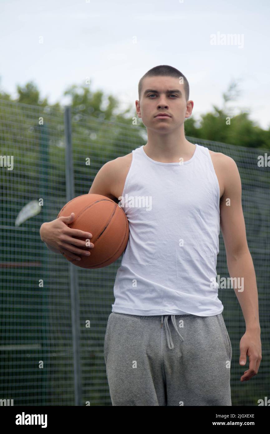 A Nineteen Year Old Teenage Boy Playing Basketball in A Public Park ...