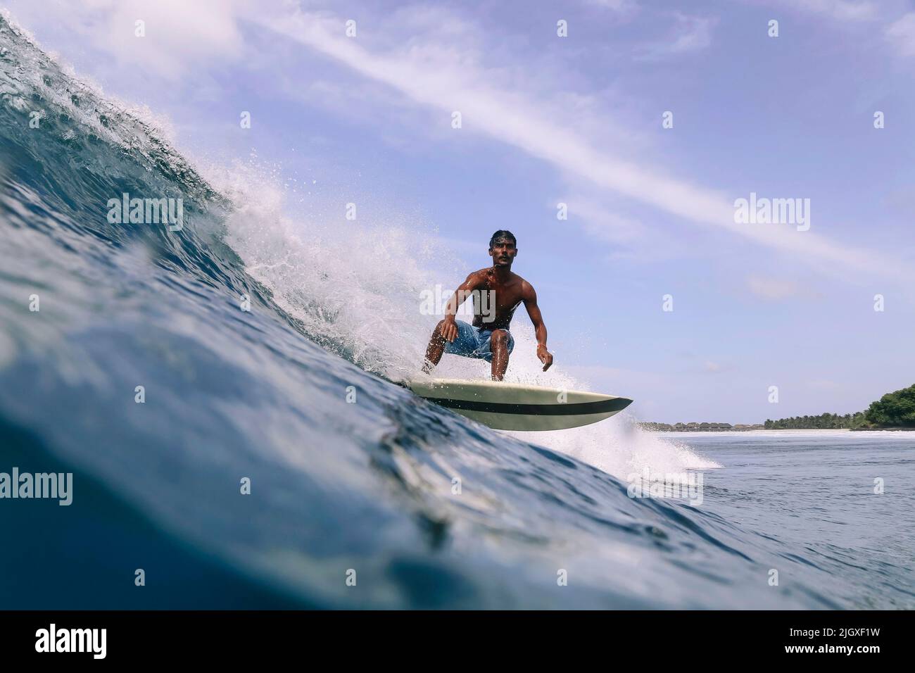 Asian surfer on a wave at sunny day Stock Photo - Alamy