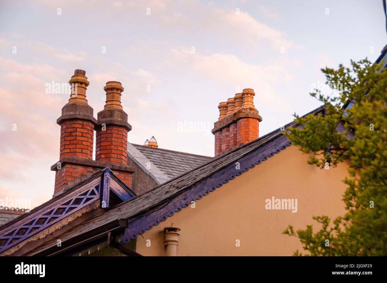 Octagonal red brick chimney stacks and decorative terra cotta rim tiles ...